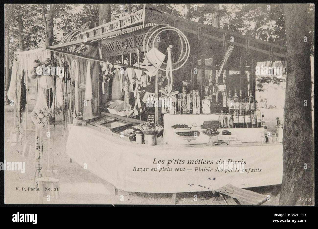 In this image, Atget captures a lively outdoor bazaar, with children ...