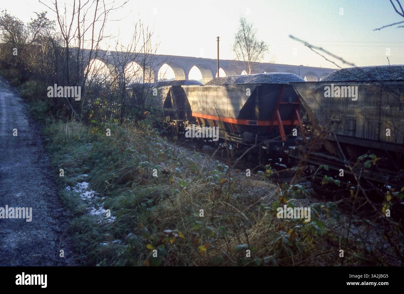 Crigglestone Viaduct with railway line and freight train carrying coal ...