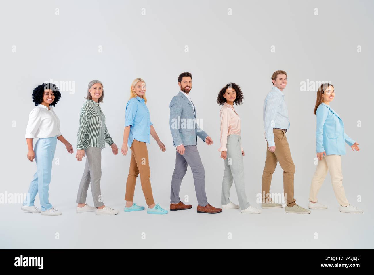 Diverse group of professionals walking together showcasing teamwork and ...