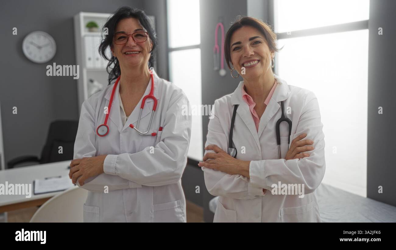 Two female doctors standing confidently with crossed arms in a modern ...