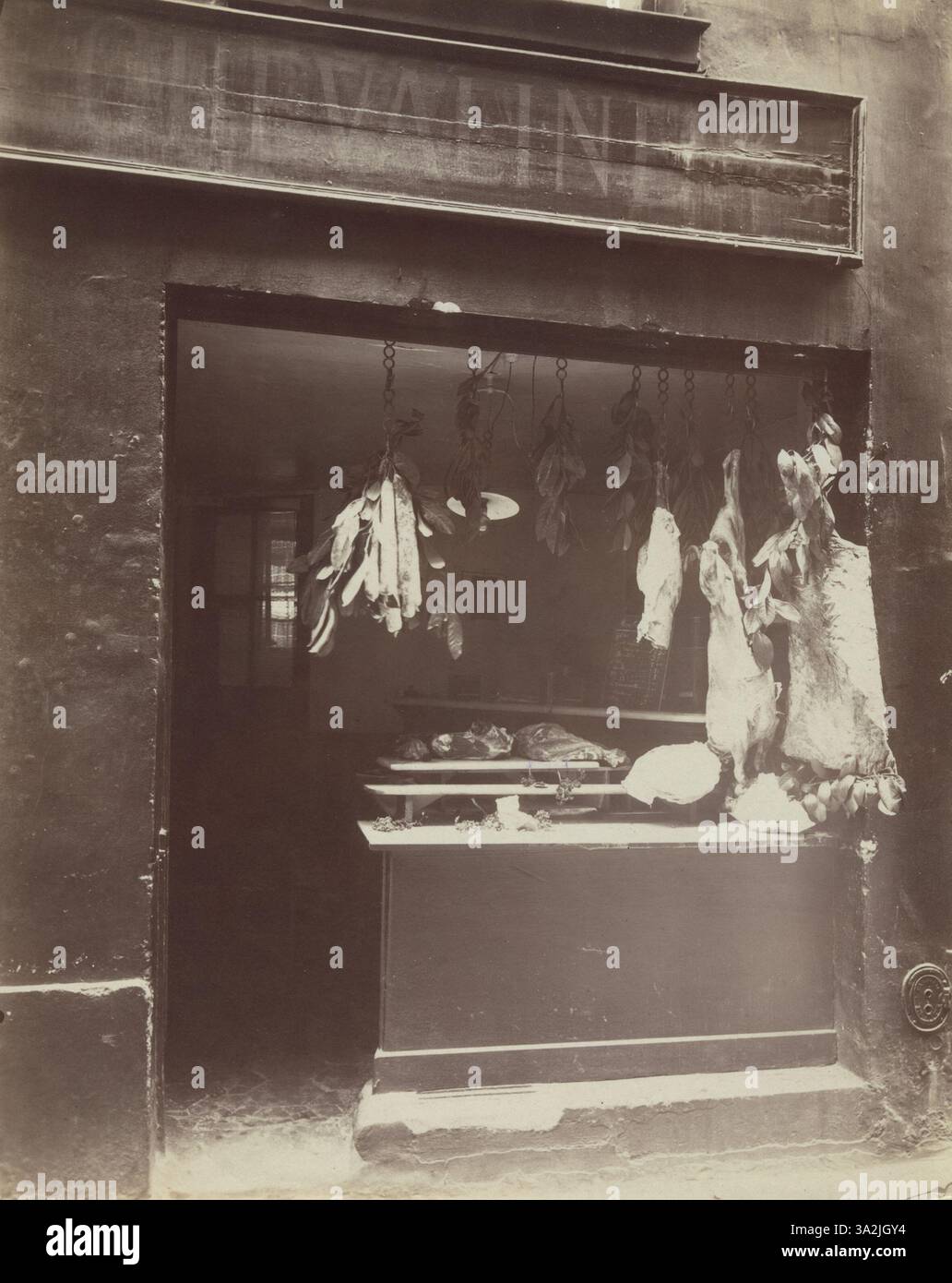 In this photograph from 1923-24, Eugène Atget documents a butcher's ...
