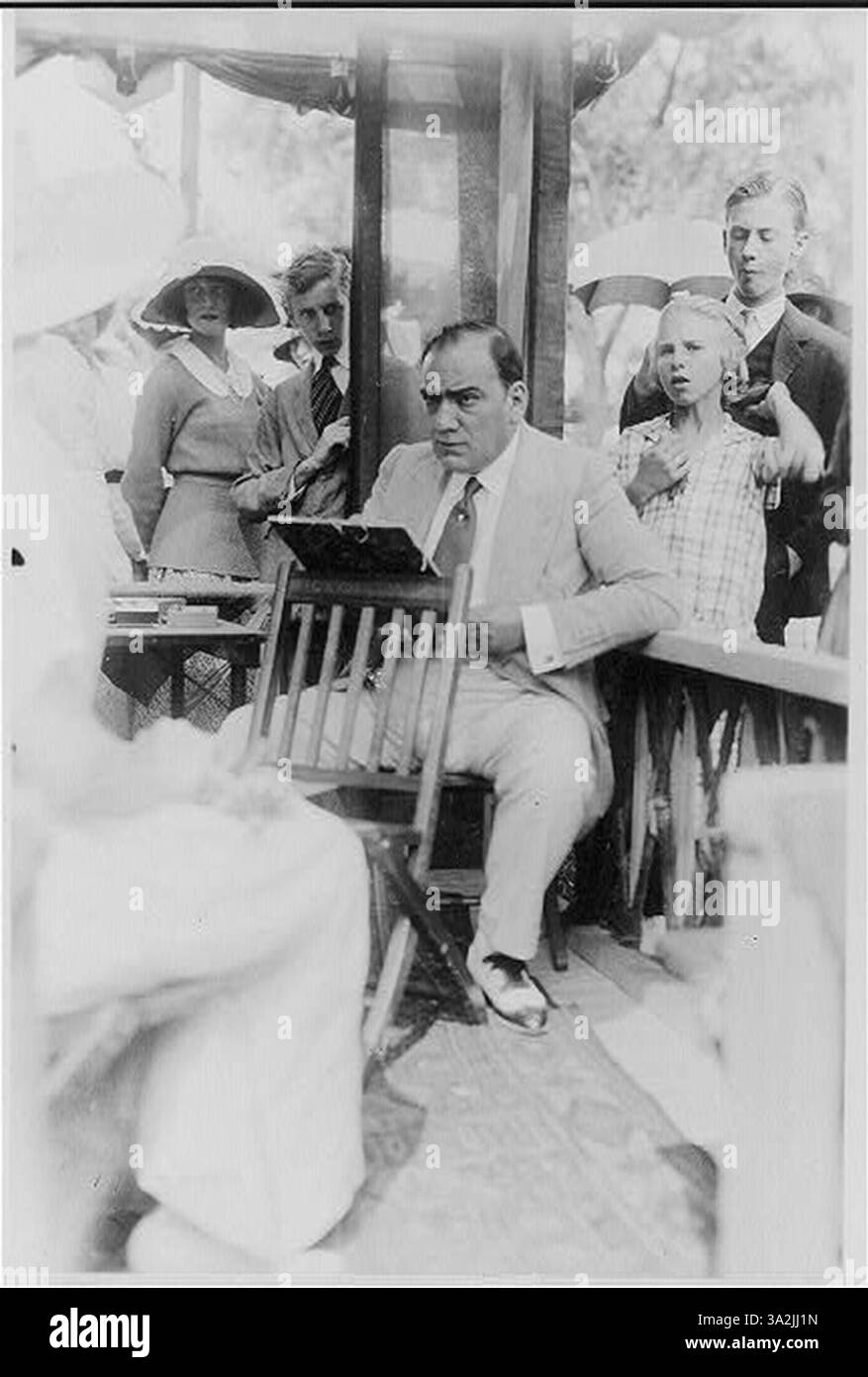 [Enrico Caruso, 1873-1921, drawing caricature sketches in booth at ...
