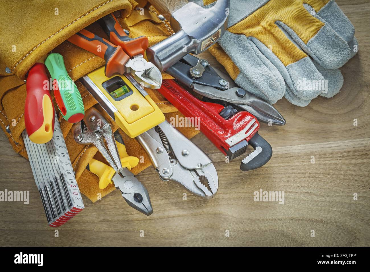 Tools in leather building belt on wooden board top view Stock Photo - Alamy