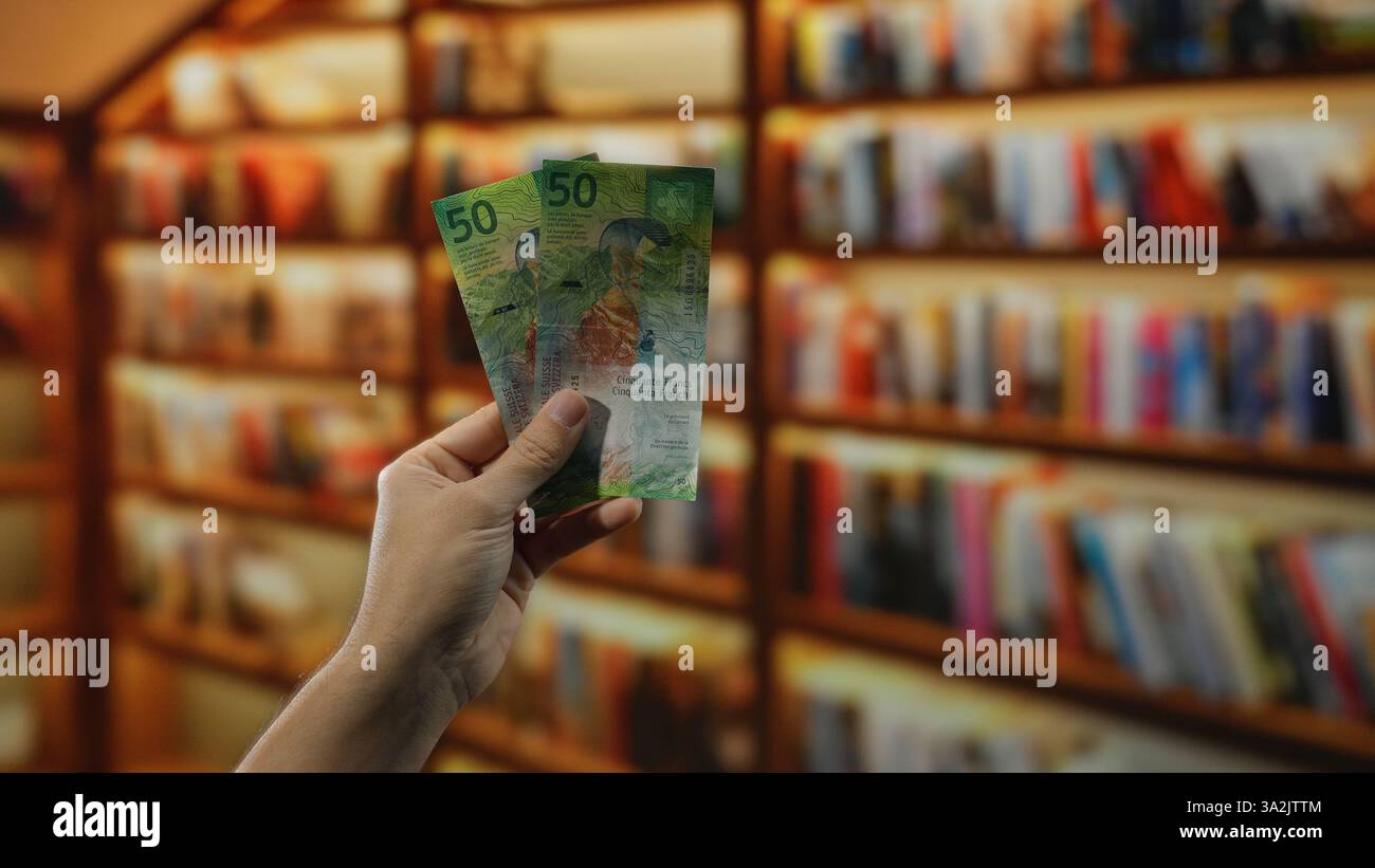 Man holding swiss franc banknotes in hand inside a cozy library with ...