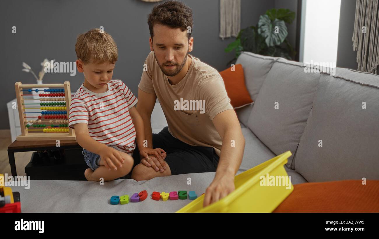 Father and son playing and learning together at home with educational ...