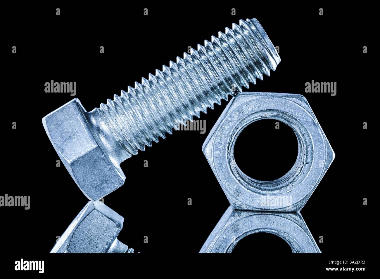 Threaded construction nut screwbolt on black surface Stock Photo - Alamy