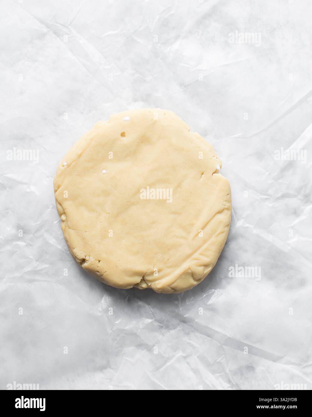 Top view of sugar cookie dough rolled between parchment paper, process ...