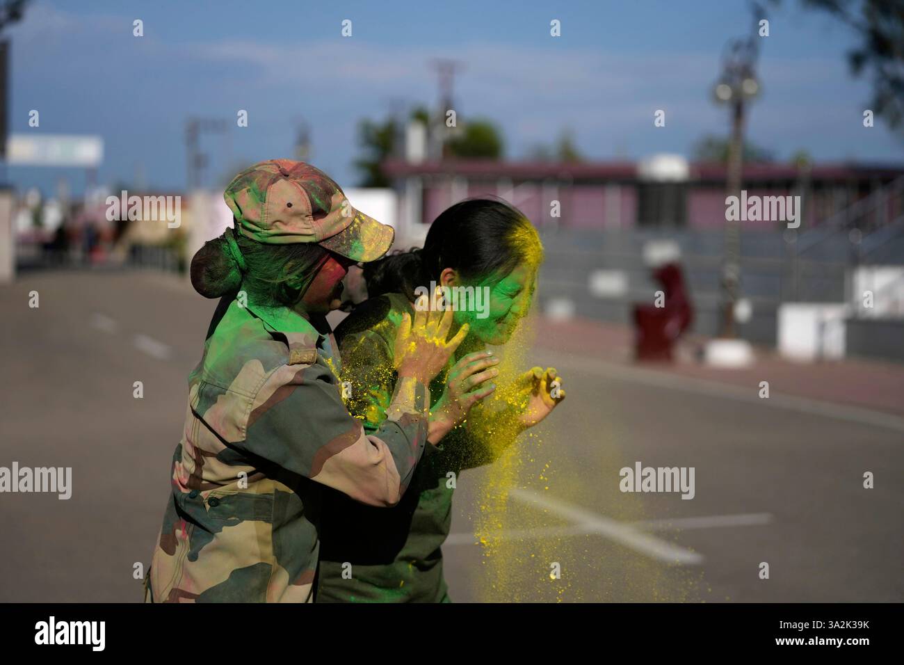 An Indian Border Security Force (BSF) soldier smears colored powder on ...