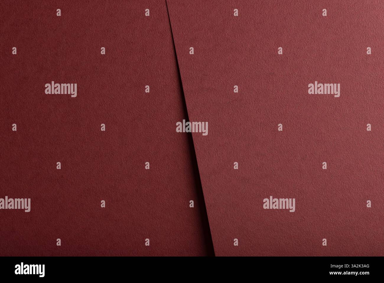 Deep burgundy paper background with a matte, grainy texture and subtle ...