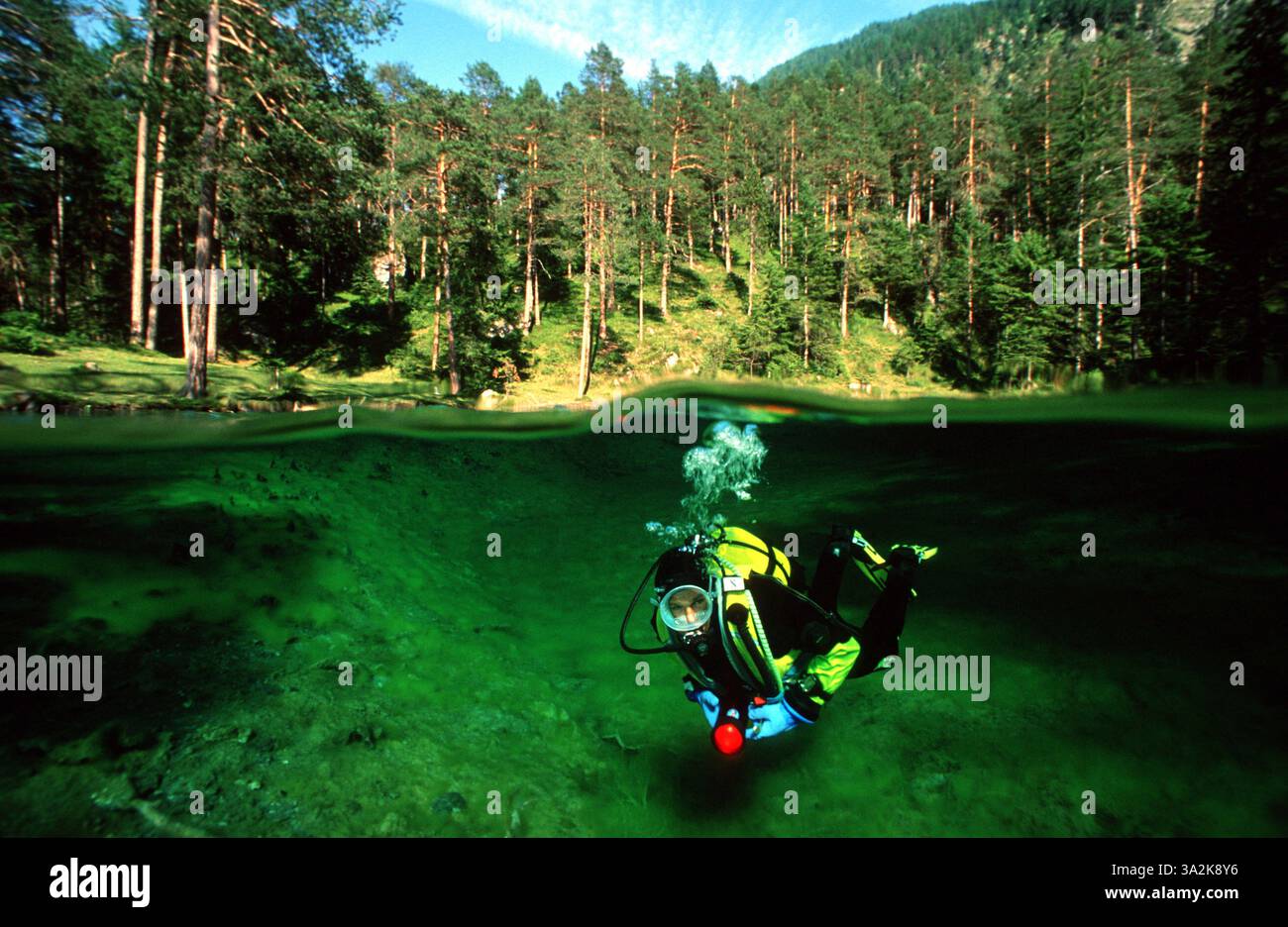 May 28, 2014 - Tyrol, Austria - Scuba diver, with a red lantern underwater, in a lake in the ...