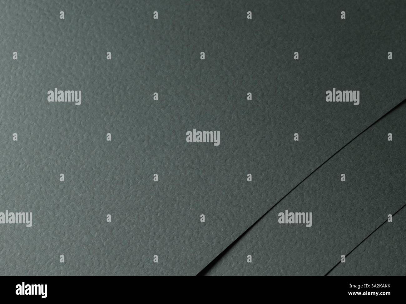 Dark green paper background with a rough, organic texture and ...