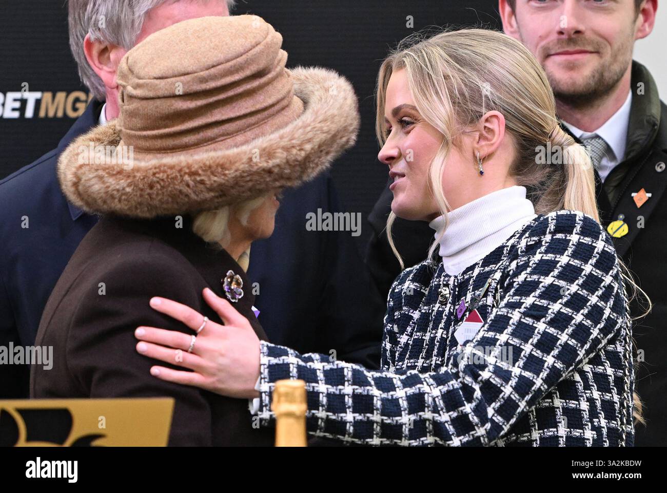 Queen Camilla (left) speaks with Charlotte Giles, girlfriend of the ...