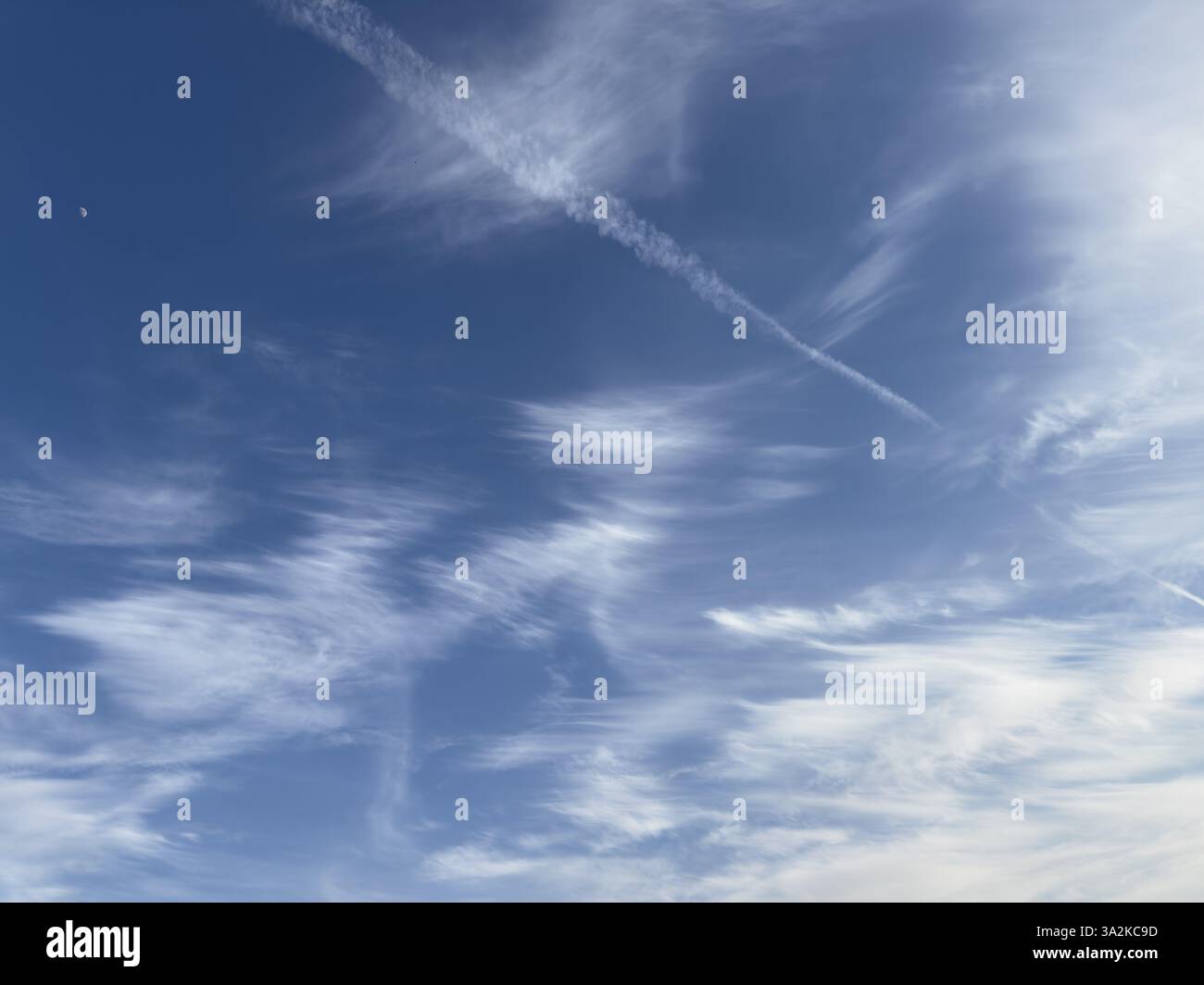 White clouds Cirrostratus veil clouds in front of blue sky, diagonal ...