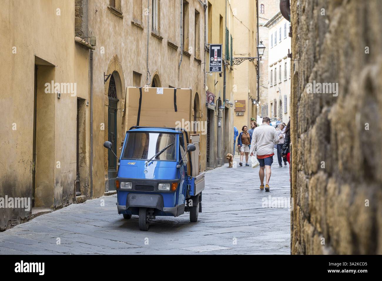 Three-wheeled Piaggio Ape van packed full in an alleyway in the ...