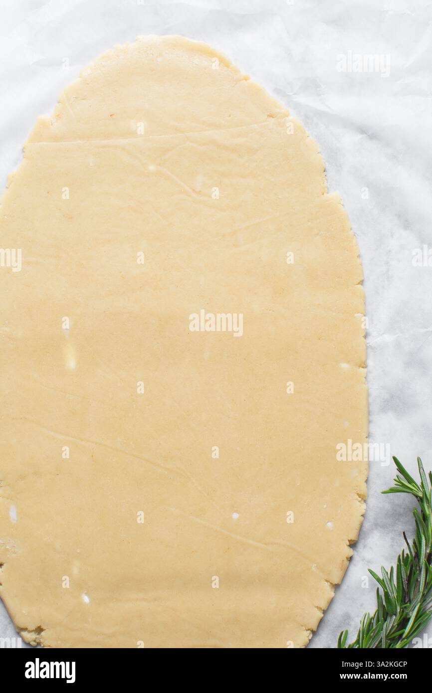 Top view of sugar cookie dough rolled between parchment paper, process ...