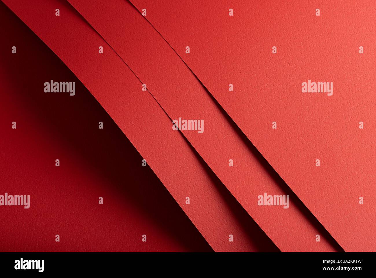 Bright red paper background with a matte texture and rough grain ...