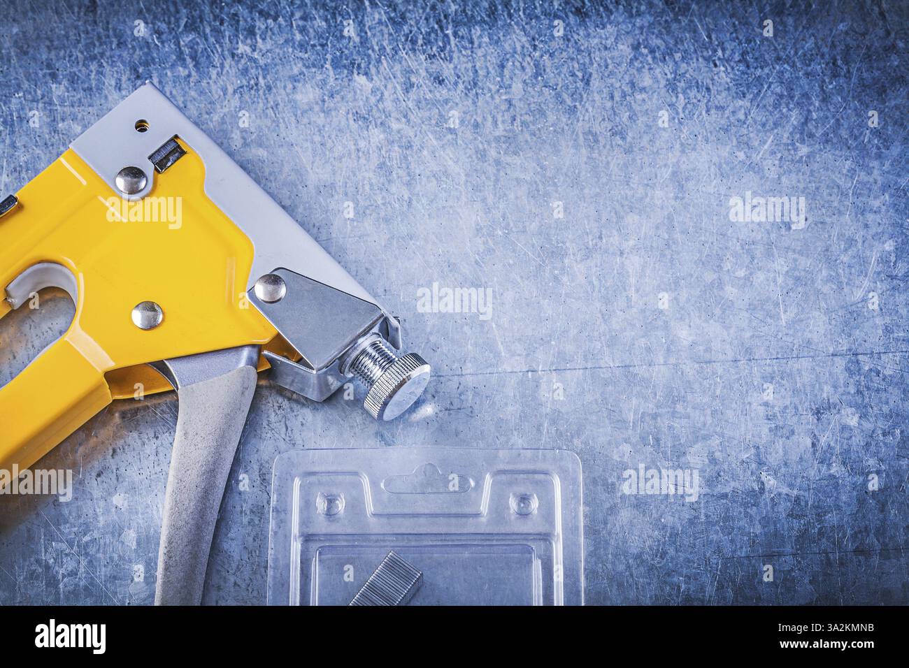Set of stapler gun chrome staples on scratched metallic background ...