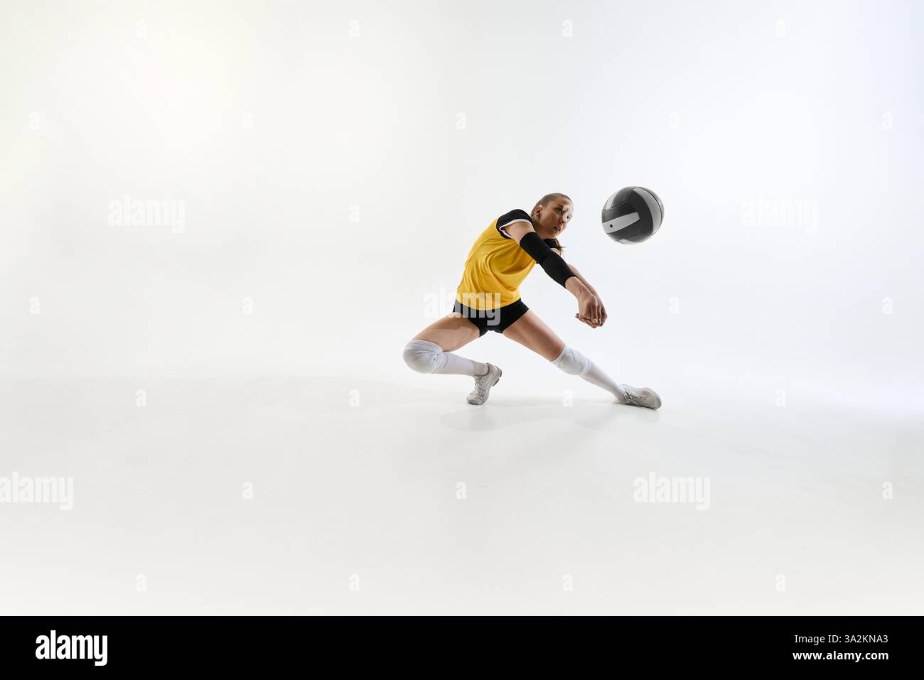 Young sportswoman, volleyball player on motion, playing fully engaged ...
