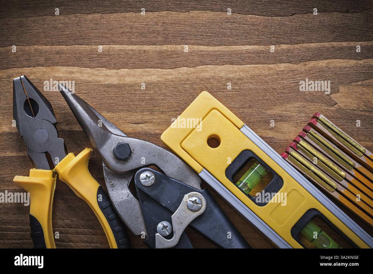 Set of pliers sharp steel cutter construction level wooden meter Stock ...