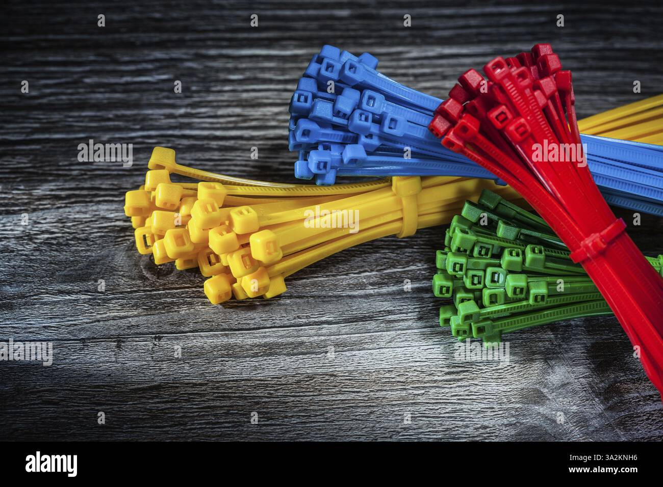 Set of plastic cables on vintage wooden board Stock Photo - Alamy
