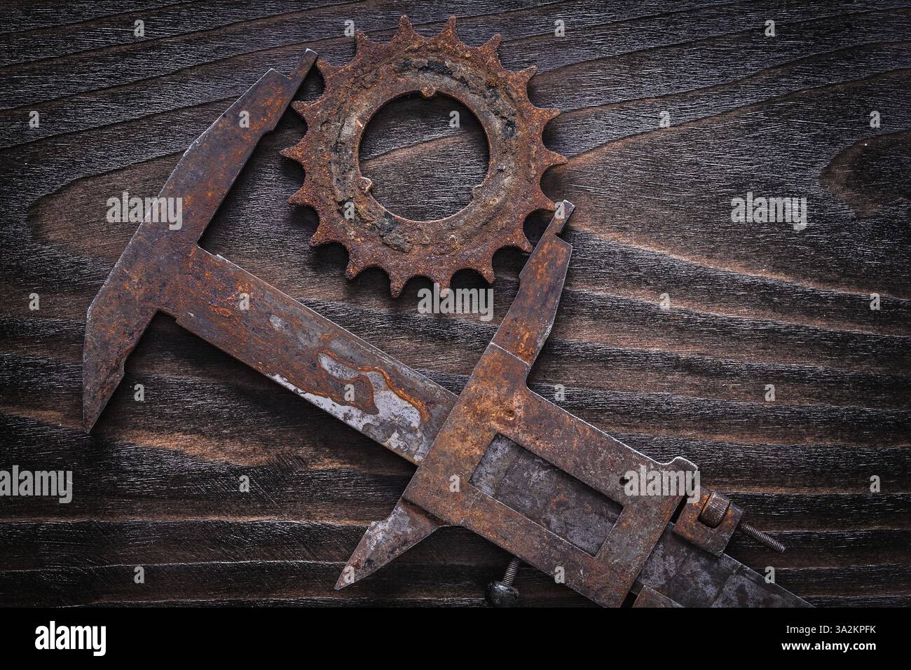 Rusted age-old measuring calipers with gear wheel on vintage dark ...