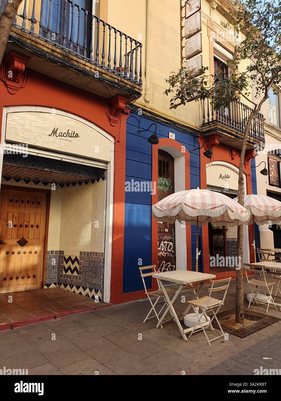 Mediterranean street scene. Outdoor cafe, tables, and umbrellas Stock ...
