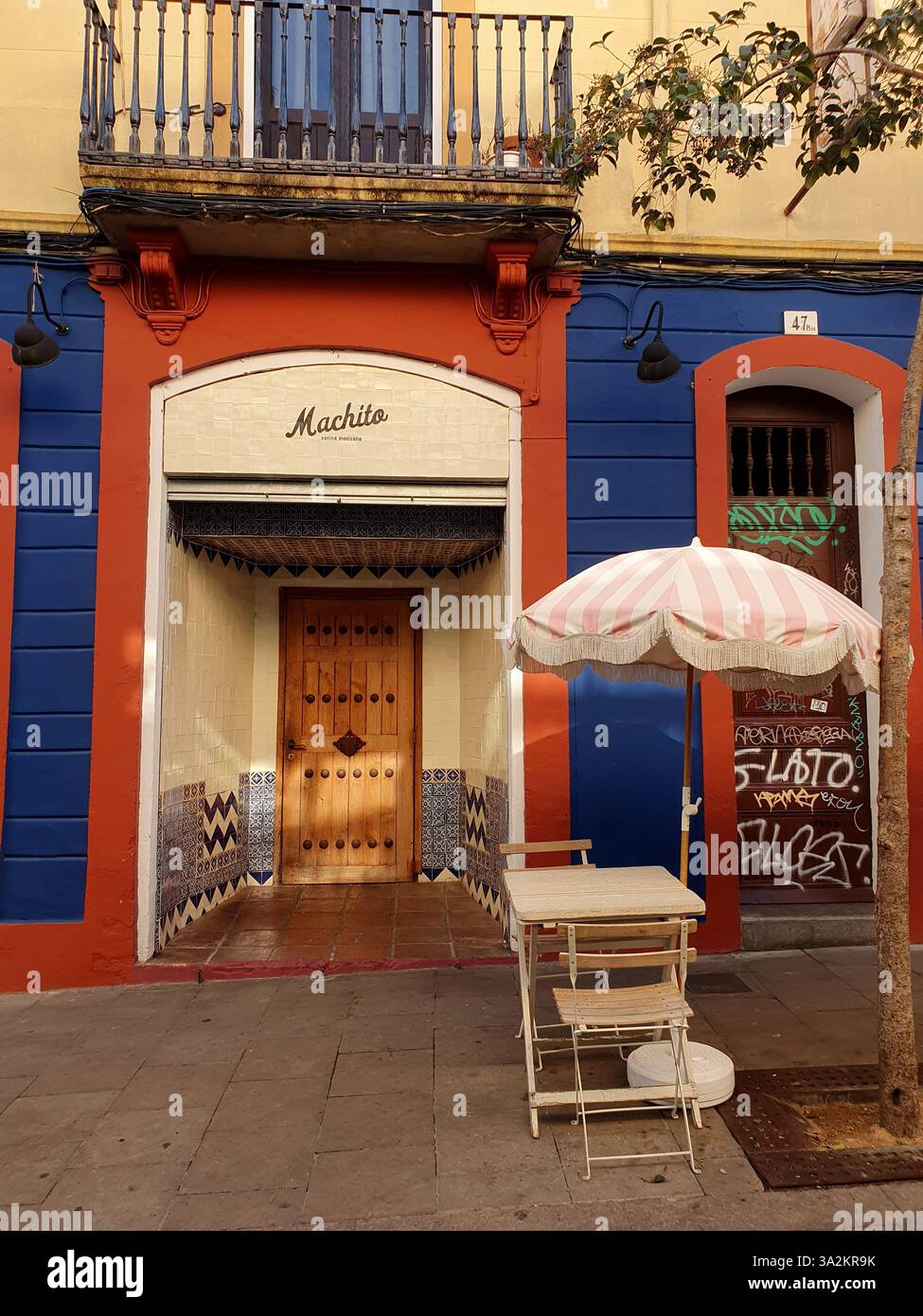 Close-up of a street scene with "Machito" storefront and outdoor ...