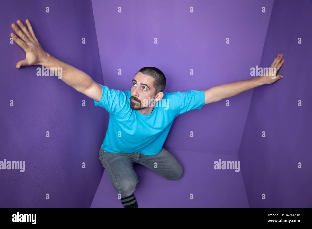 A man inside a vividly colorful box expresses a range of emotions and a ...