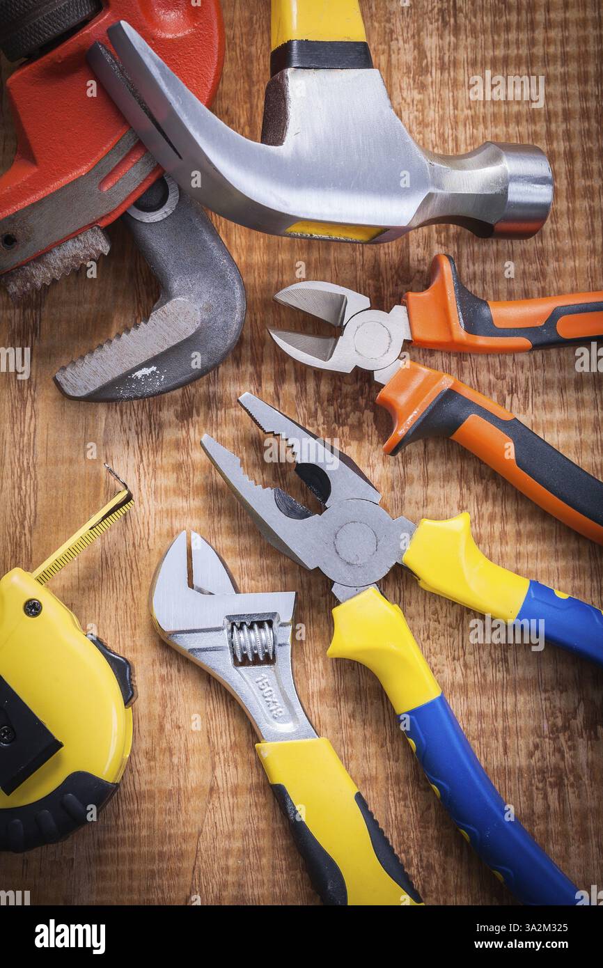 Set o f tools on wooden board tapeline adjustable wrench hammer nippers ...