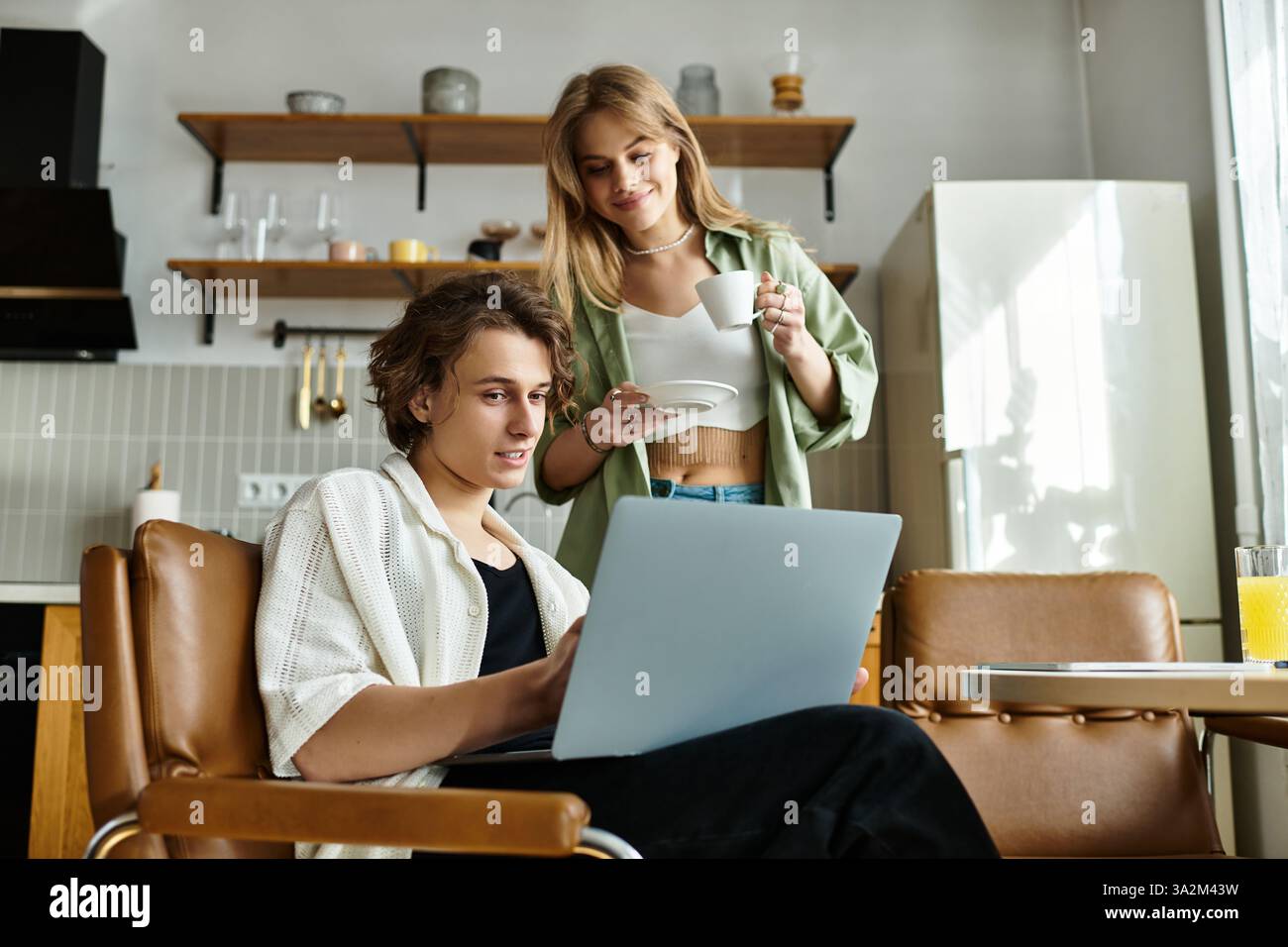 A loving couple shares a comfortable time at their modern home, engaged ...