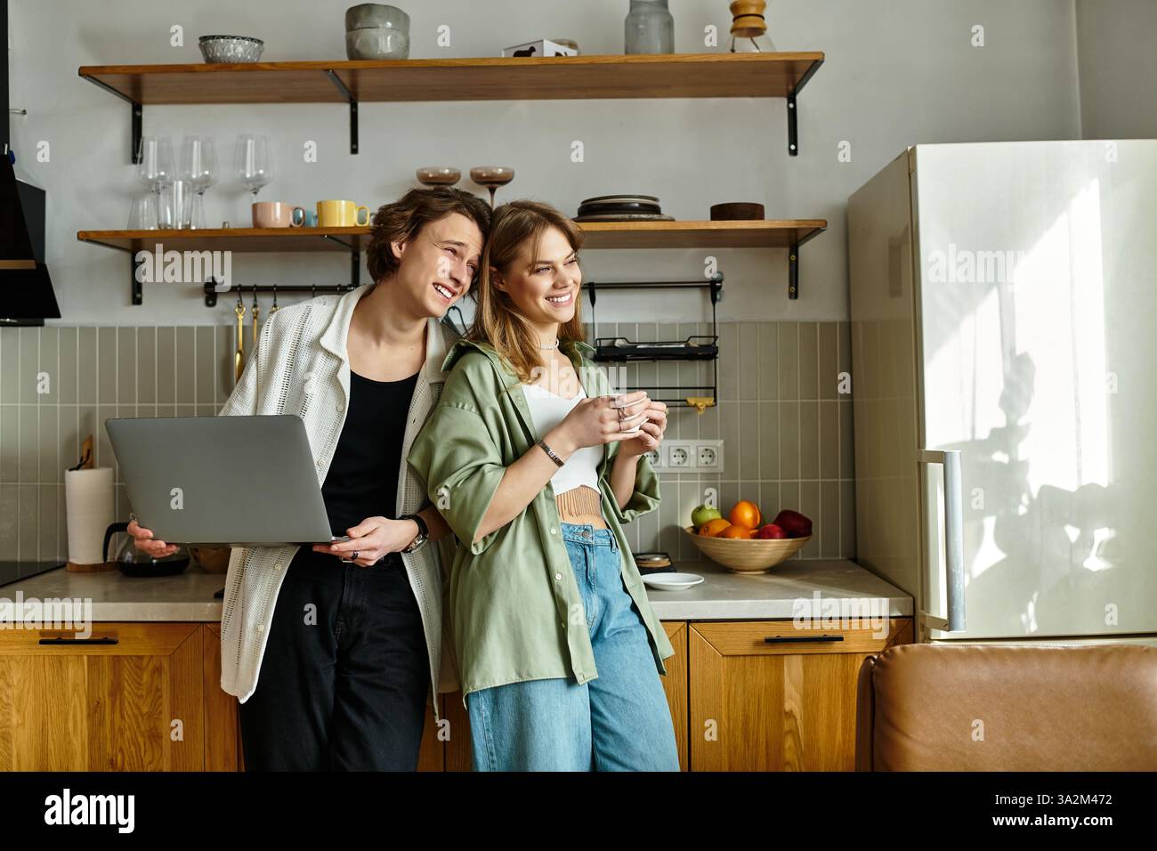 Loving couple enjoys a relaxed moment in their comfy kitchen while ...