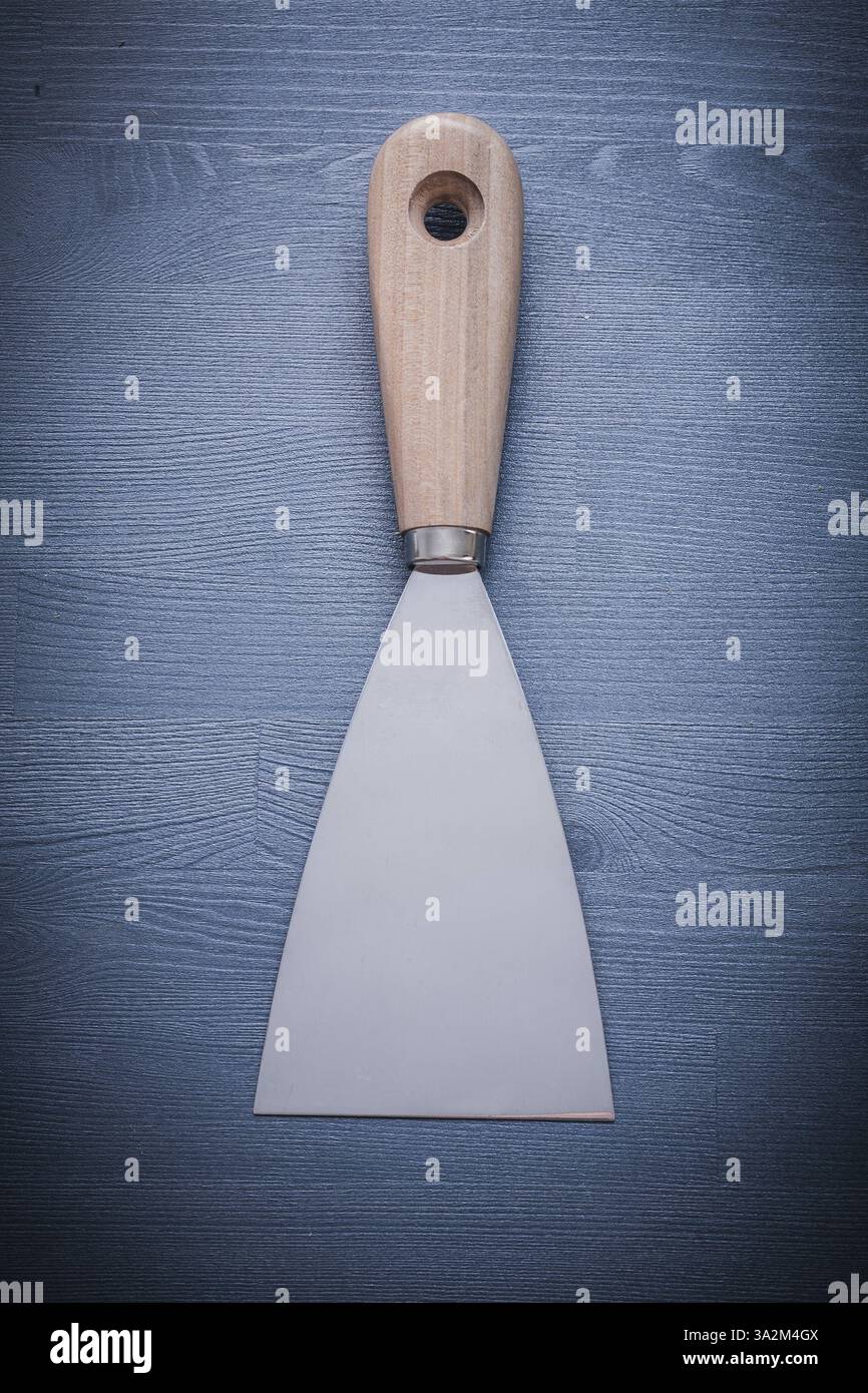 Single paint scraper with wooden handle Stock Photo - Alamy