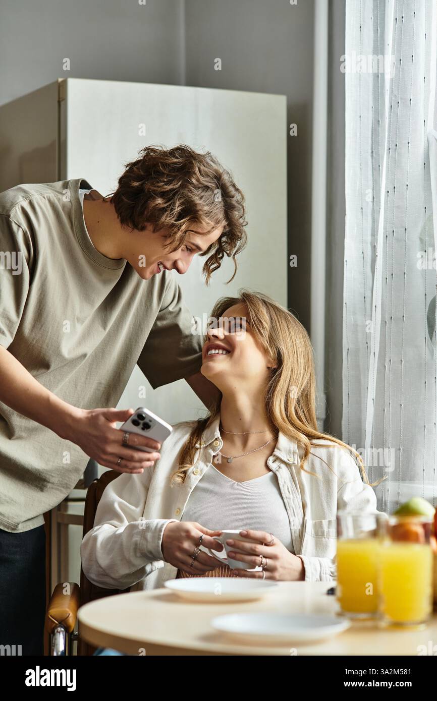 A young couple shares a heartfelt exchange at home, basking in warmth ...