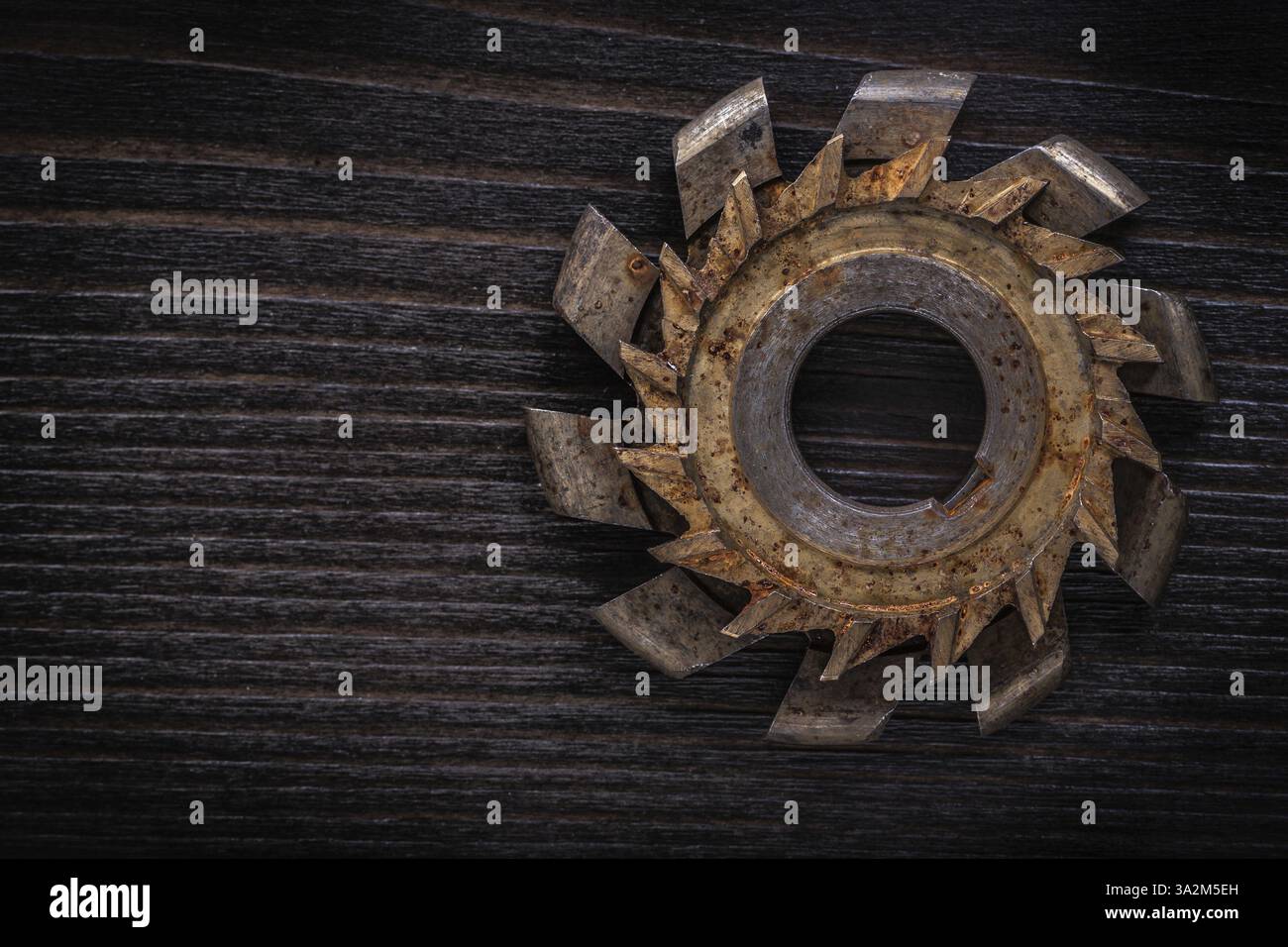 Rusty rotary cutter on vintage wooden background construction concept ...