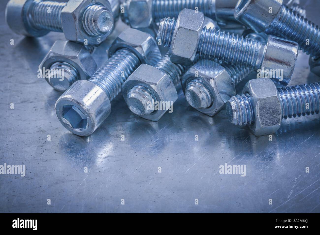 Stainless bolts and nuts on metallic background construction concept ...