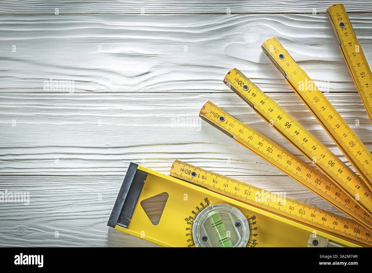 Wooden meter construction level on white board Stock Photo - Alamy