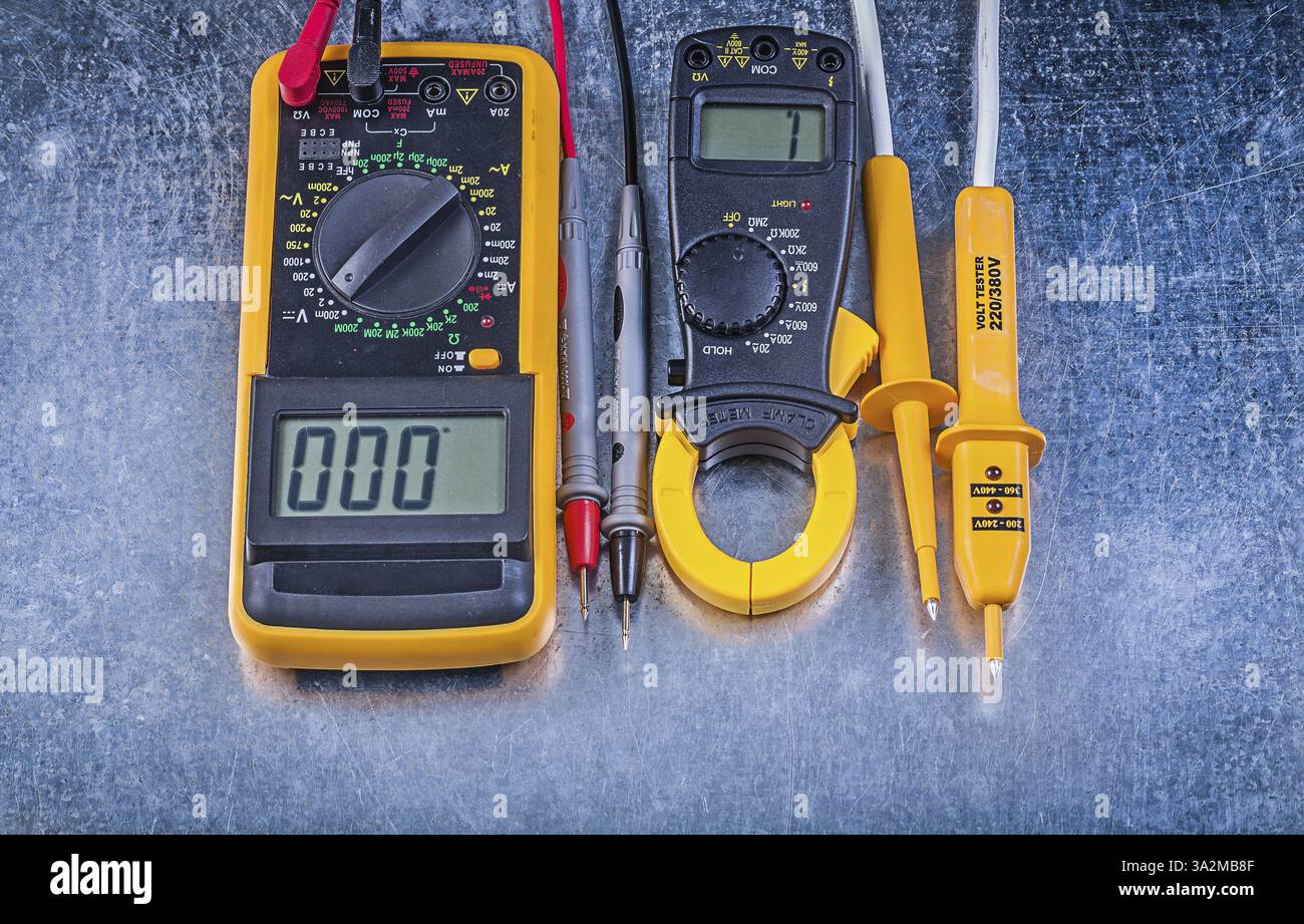 Set of digital clamp meter electric tester multimeter on metallic ...