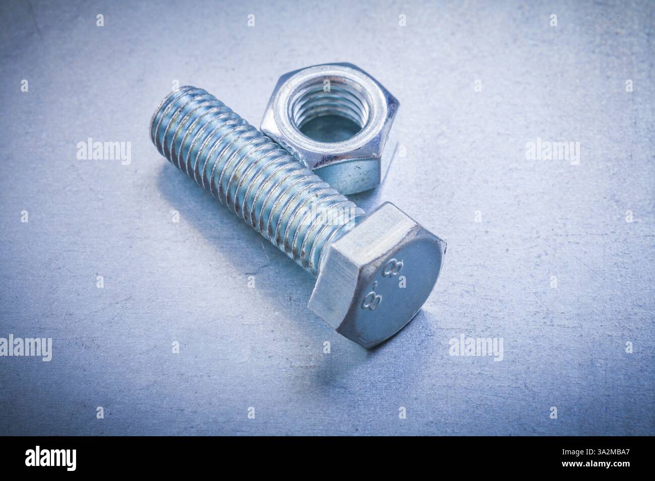 Stainless construction bolt and nut on metallic background repairing concept Stock Photo - Alamy