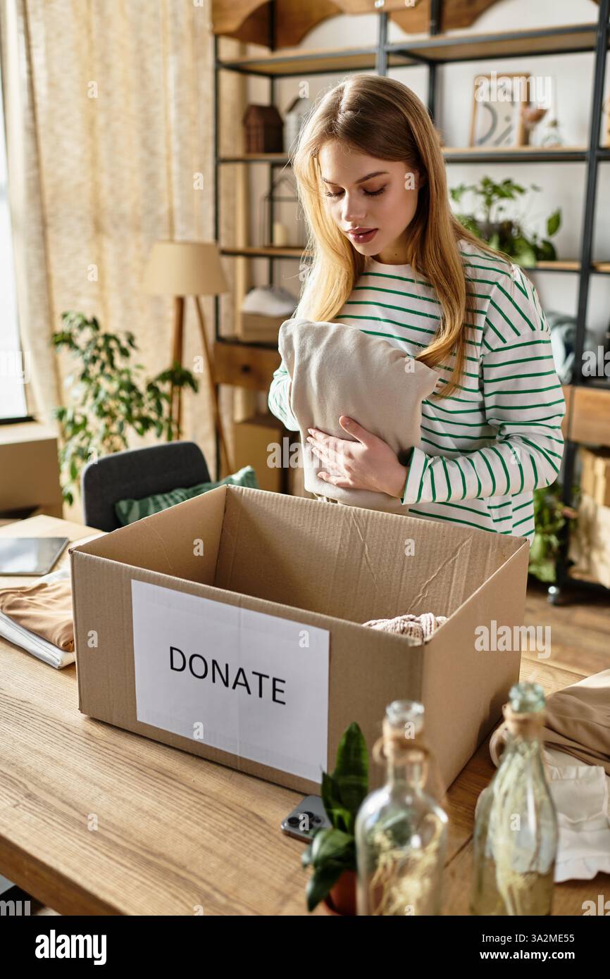 A young woman organizes her clothing to donate, embracing ...