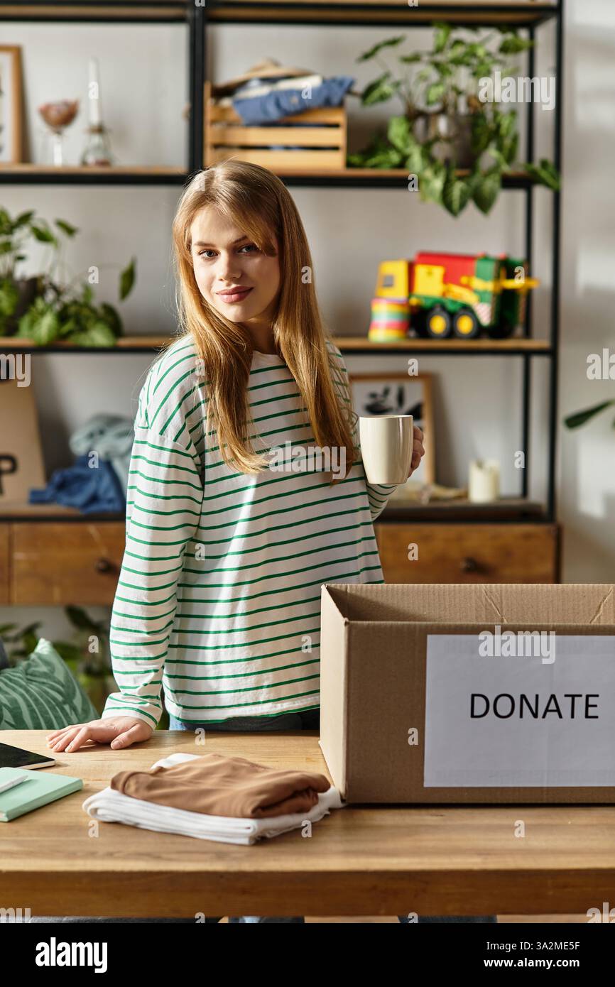 Brightly lit room where a young woman sorts clothes for donation ...