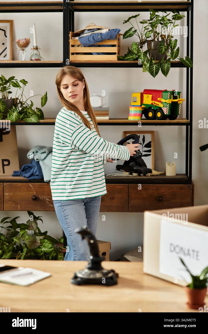 Young woman dedicating time to sort and donate video game stuff in her ...