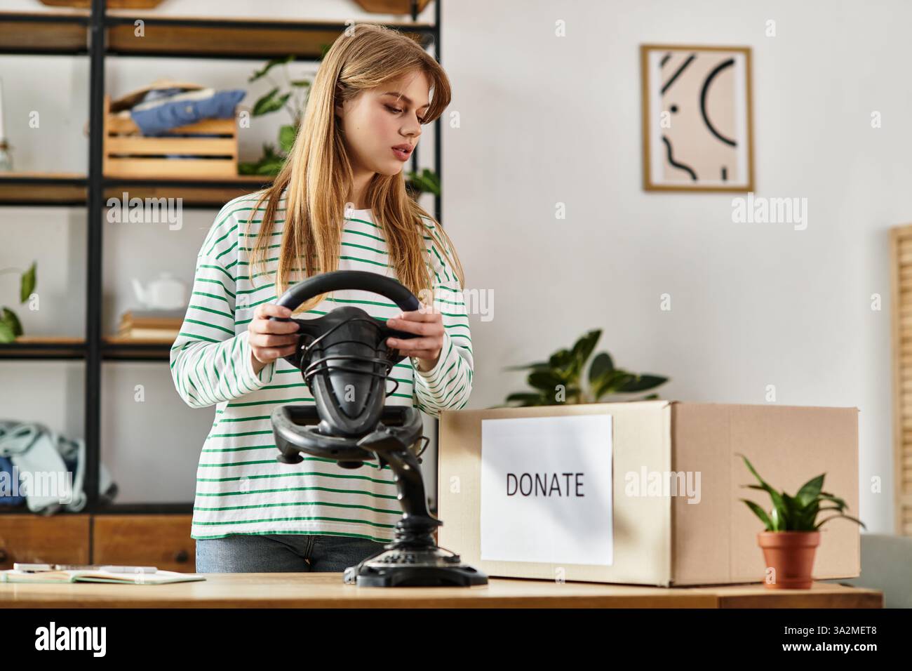 Young woman actively sorting video game items for donation, promoting a ...