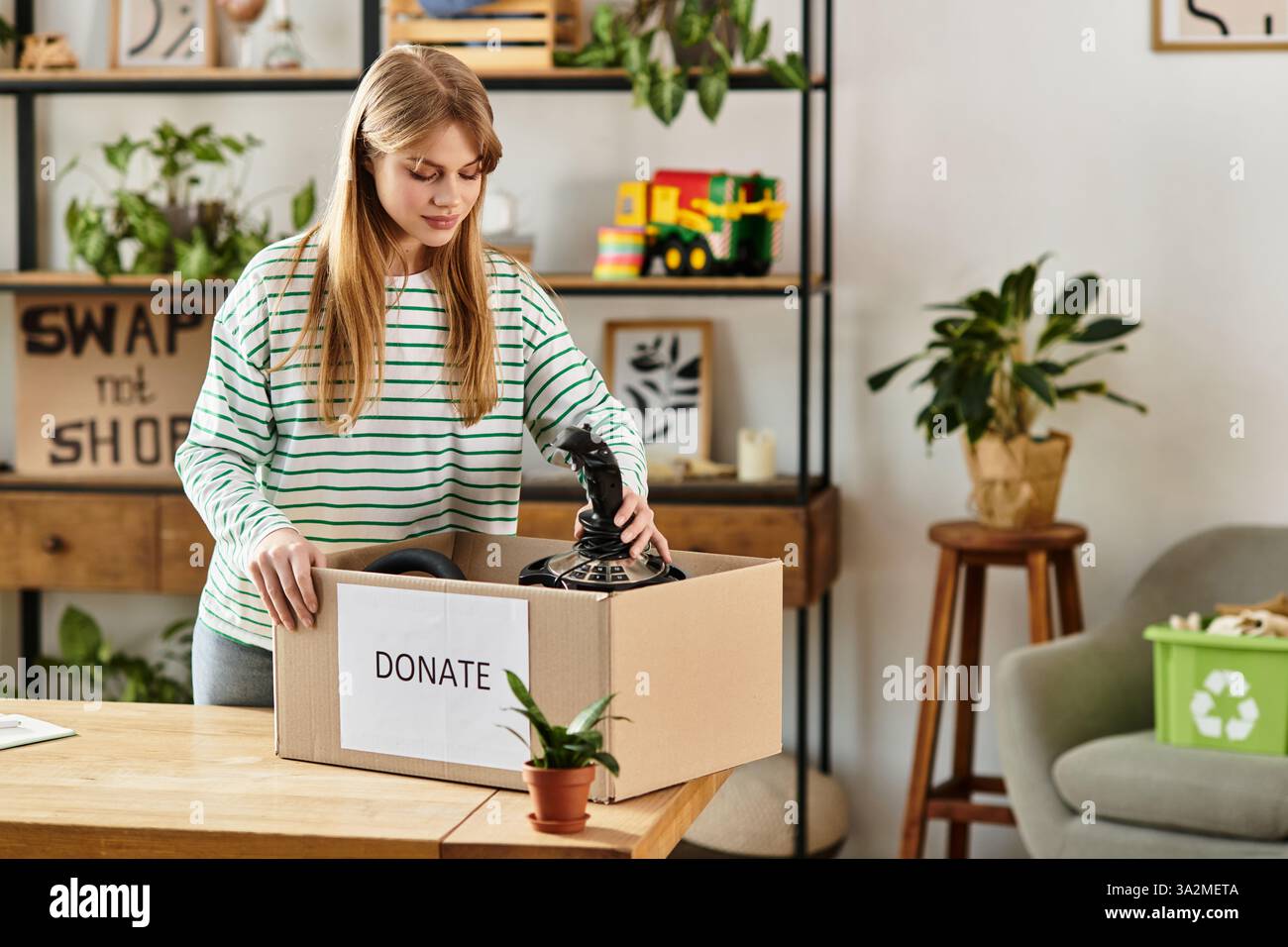 Sorting clothes and placing them in a donation box, embracing a ...