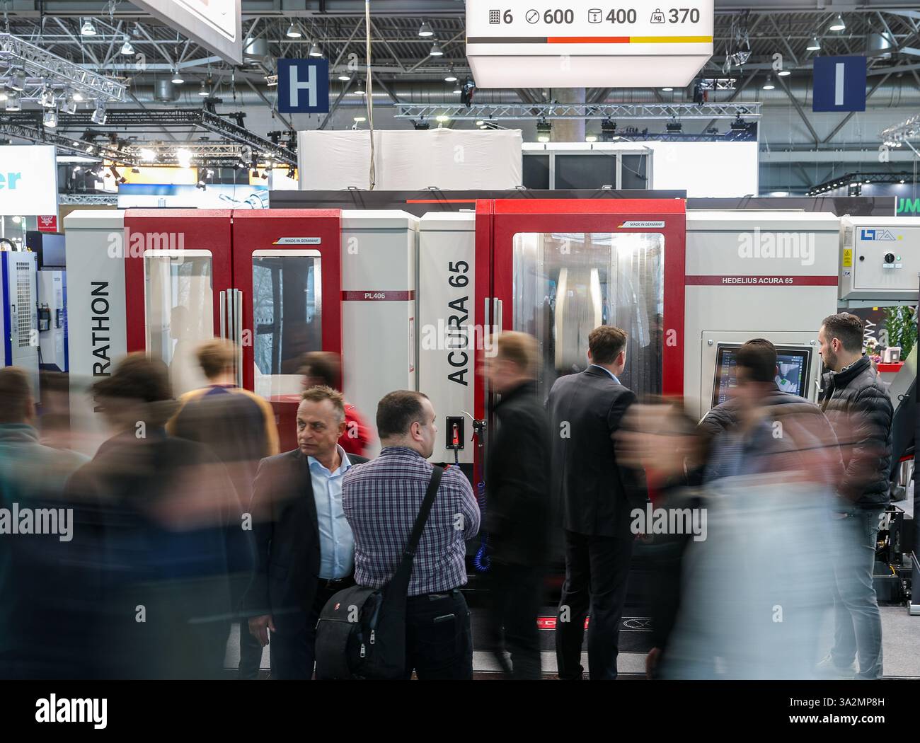Leipzig, Germany. 13th Mar, 2025. Visitors walk past a Hedelius Acura ...