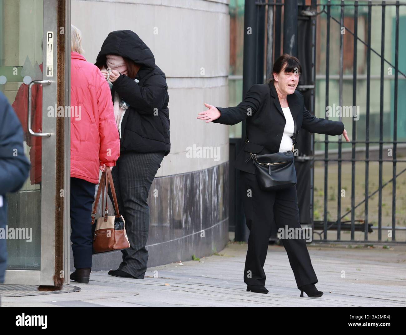 A woman remonstrates with the waiting media as the mother of Lewis ...