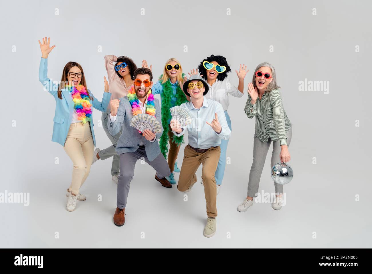 Diverse group of colleagues celebrating together in festive attire ...