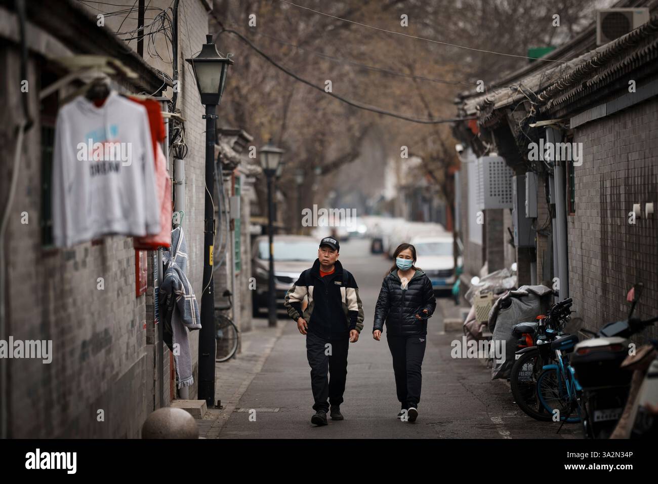 Local walk along an alley way in Hutong area in Beijing, China ...