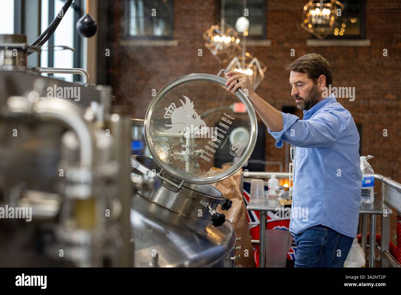 Jeff Ware, president of Resurgence Brewing Company, opens a vat in ...