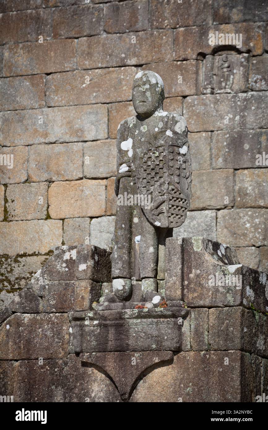 Stone figure in the Church of San Benito de Cambados, a warrior adorned ...