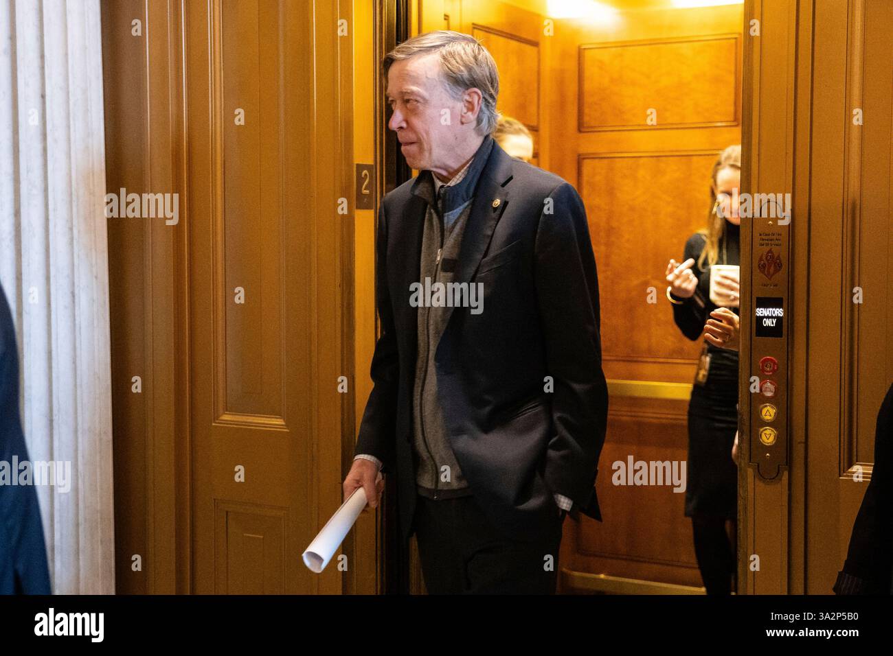 Sen. John Hickenlooper (D-Colo.) arrives for a vote at the U.S. Capitol ...
